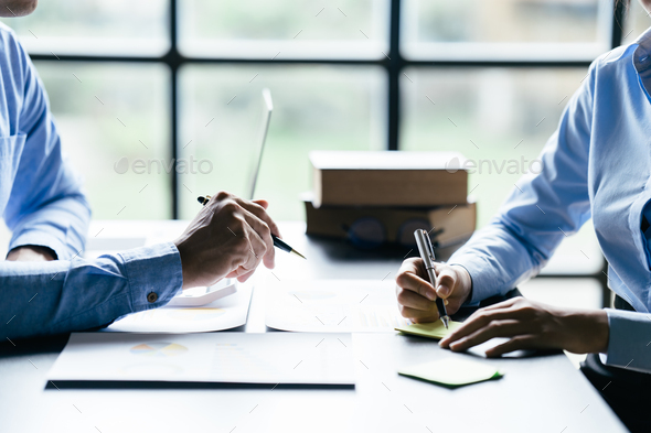 Business team reviewing a diagram or chart and financial reports Stock ...