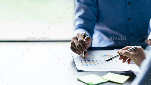 Business team reviewing a diagram or chart and financial reports Stock ...