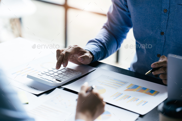 Business team reviewing a diagram or chart and financial reports Stock ...
