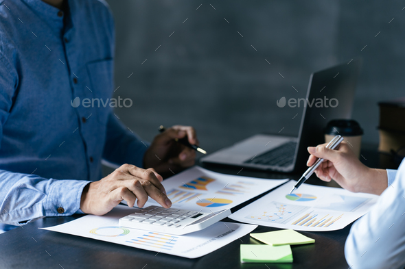 Business team reviewing a diagram or chart and financial reports Stock ...