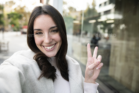 happy smiling beautiful woman taking a selfie in the city - portrait of ...