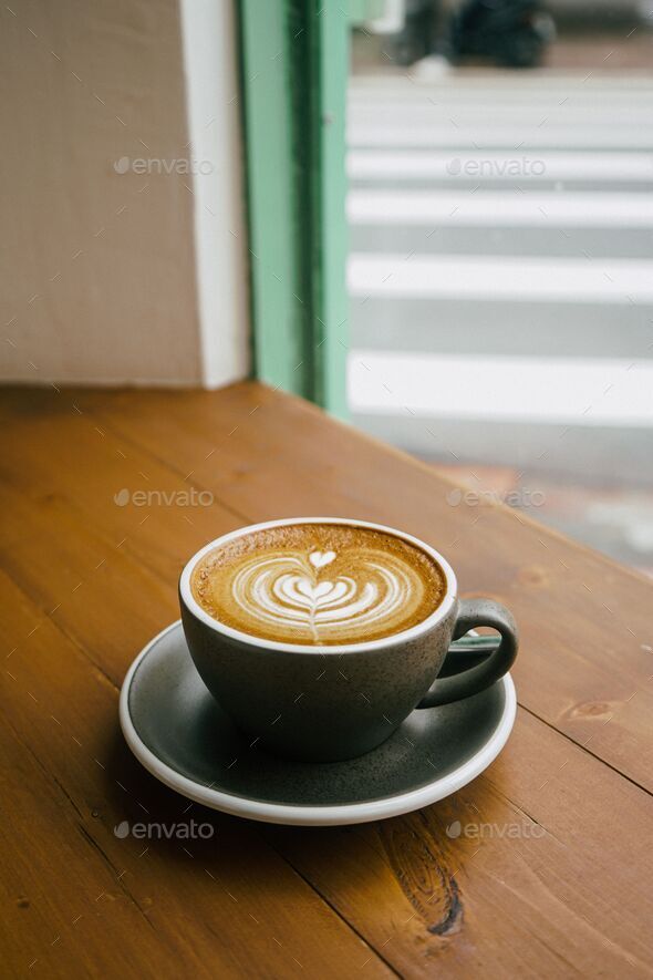 Vertical shot of coffee with grey cup above wooden table in a coffee ...