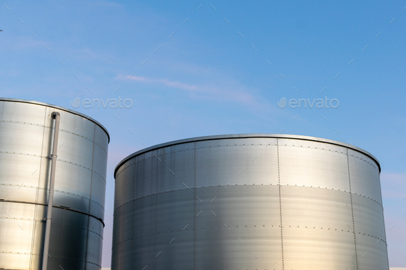 Outside large metal tanks on a clear blue sky background Stock Photo by ...