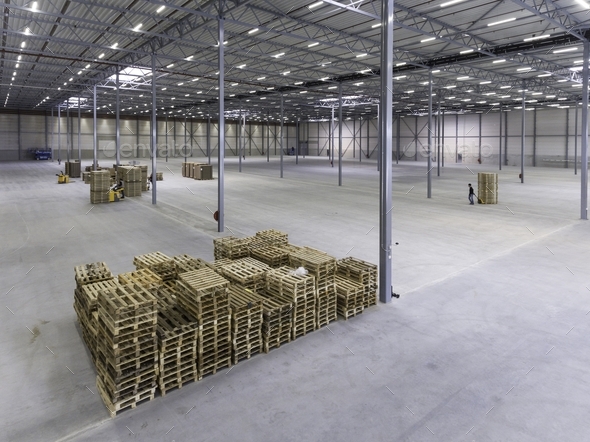 Modern warehouse with workers working with industrial items Stock Photo ...