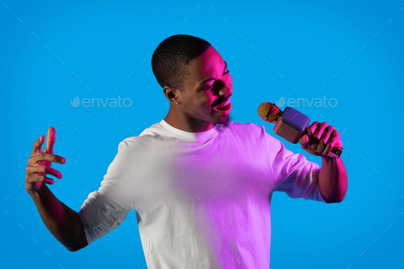 Cool black guy rapper singer performing on blue Stock Photo by Prostock ...