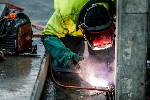 Closeup of a construction worker using a flame torch to cut up heavy ...