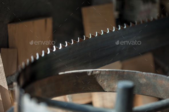 Closeup shot of a sharp metal saw captured in a factory under the ...