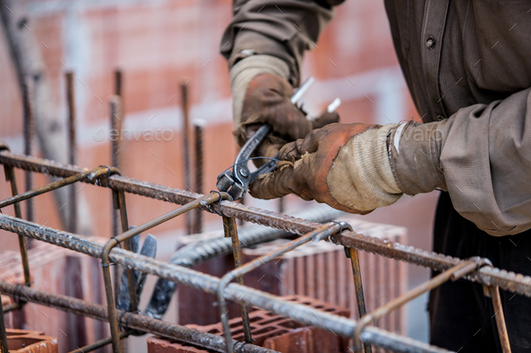 Construction worker installing binding wires on the reinforcement Stock ...