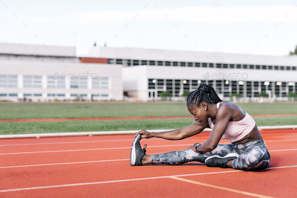 Athlete sprinter stretching her legs Stock Photo by nunezimage | PhotoDune