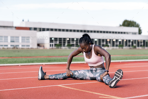 Athlete sprinter stretching her legs Stock Photo by nunezimage | PhotoDune
