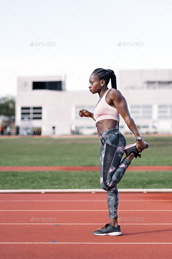 Athlete sprinter stretching her legs Stock Photo by nunezimage | PhotoDune