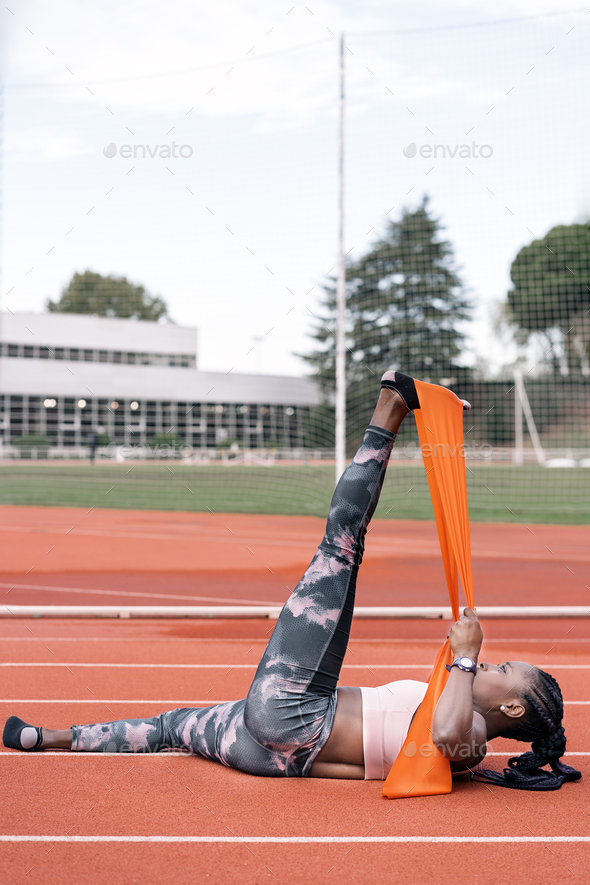Athlete sprinter stretching her legs Stock Photo by nunezimage | PhotoDune