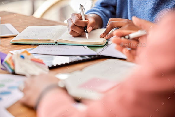 Meeting, planning and team writing notes while in discussion on a ...