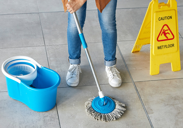 Floor mopping, cleaning sign and mop bucket with water and woman doing ...