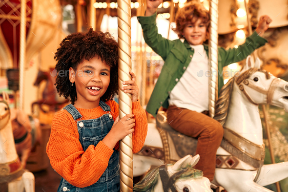 Kids having fun on a carnival Carousel Stock Photo by ORION_production