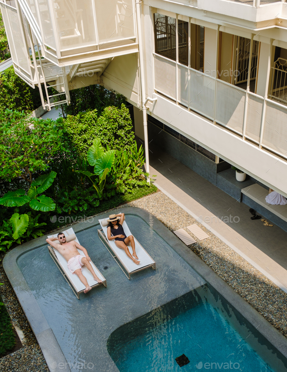 couple at a swimming pool at an art deco luxury hotel architecture from ...