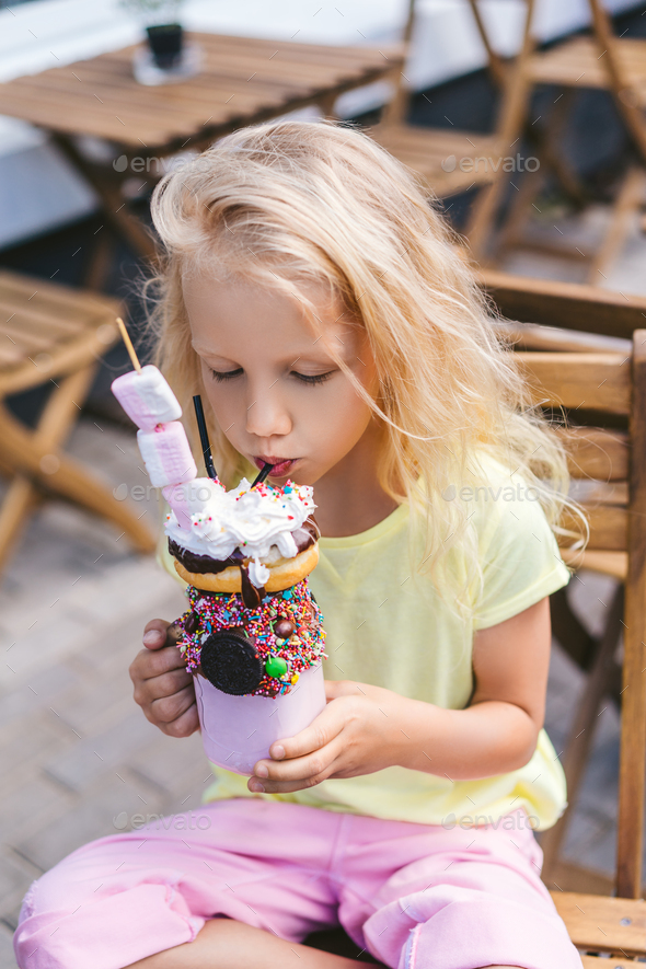 selective focus of adorable little child with closed eyes eating ...