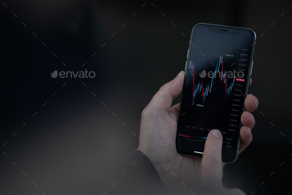 Male hand touching smartphone screen with financial graph chart Stock ...
