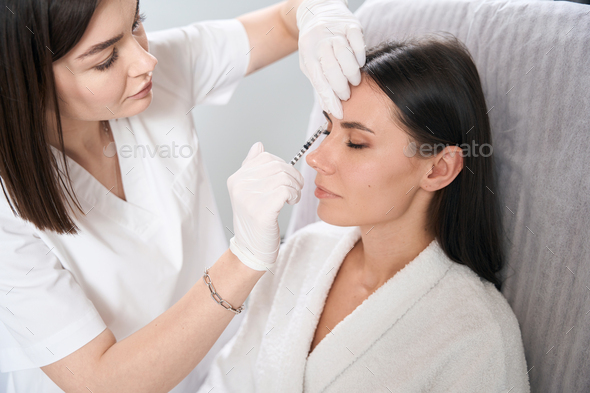 Pretty lady on injection procedure for facial skin nutrition Stock ...