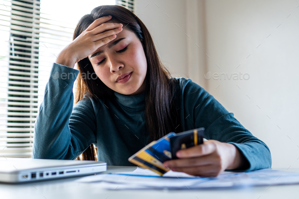close up woman's hand holding three credit cards, feeling stressed ...