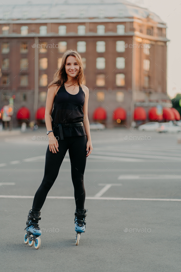 woman going rollerblading dressed in active wear spends free time ...