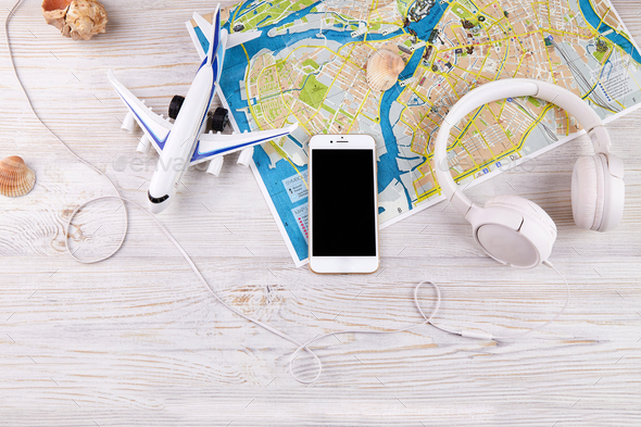 Airplane, map, straw hat, phone and other accessories for a traveler ...