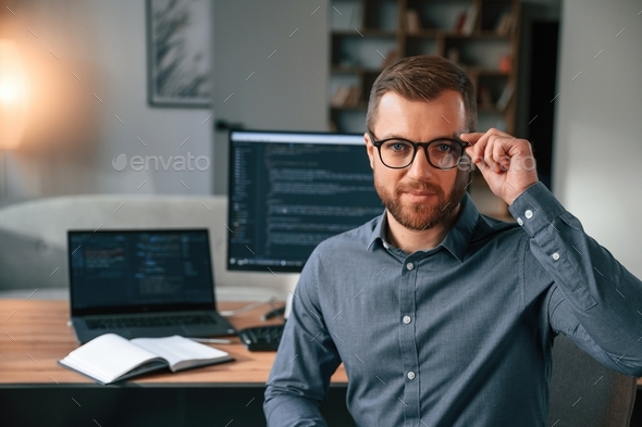 Man in formal clothes is working in the modern office. Using computer ...