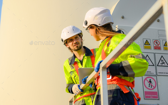 Engineer technician with safety uniform working at wind turbine field ...