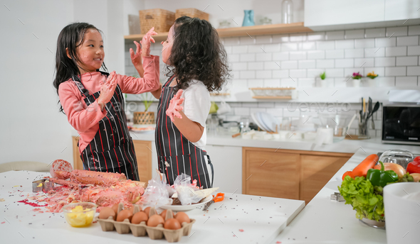 Child making cake with family, Family having fun together in kitchen ...