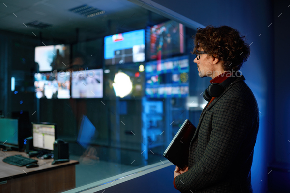 Man looking at computer screen reflection in server room window Stock ...