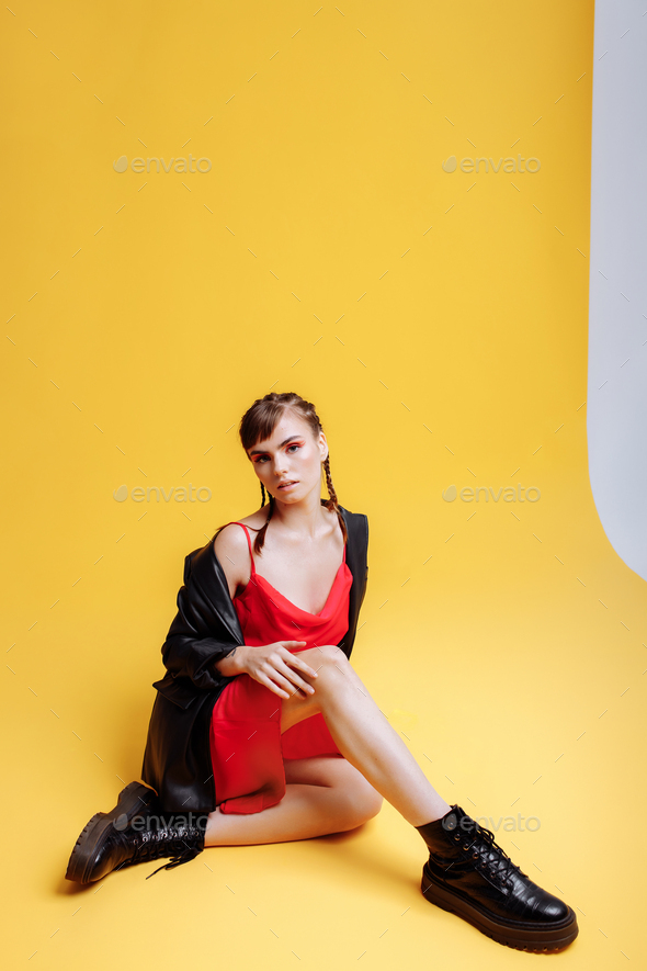Beautiful female model in a red dress yellow background Stock Photo by ...