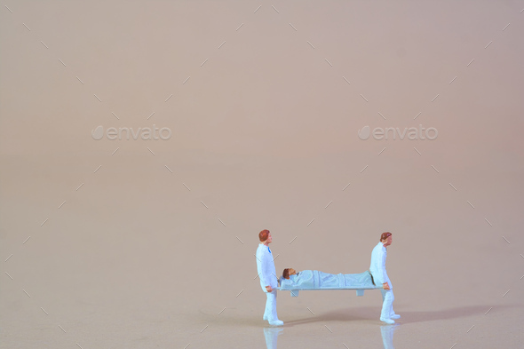 two male nurses in white coats carry a patient with a stretcher Stock ...