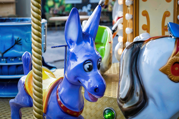 Donkey carousel at the fairground .The old carousel in the Park of ...