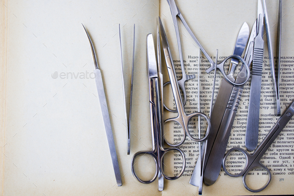 Top view of a medical dissection kit on an open book Stock Photo by ...