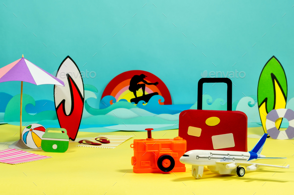 Creative paper craft of a surfer on the waves with baggage, plane and ...