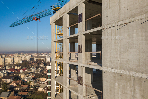 Aerial view of concrete frame of tall apartment building under ...