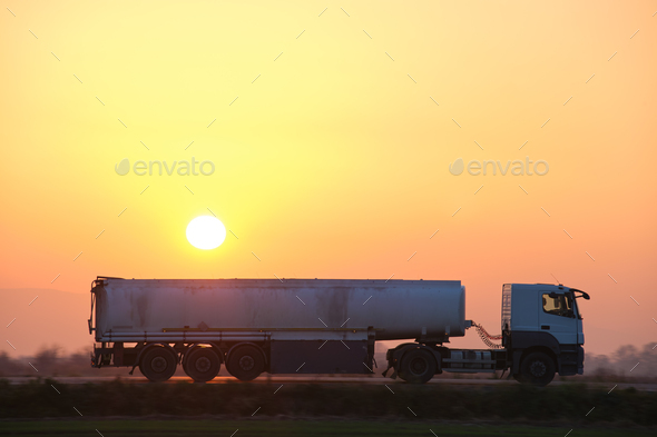 Semi-truck with tipping cargo trailer transporting sand from quarry ...