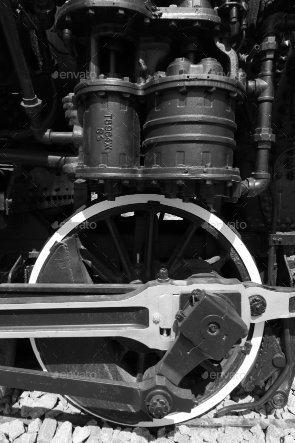 Grayscale shot of an old steam locomotive wheel Stock Photo by wirestock