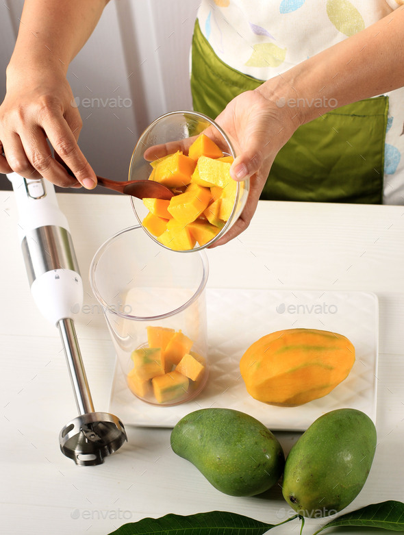 Pour Diced Mango to the Juicer Bowl, Process Making Mango Smoothie or ...