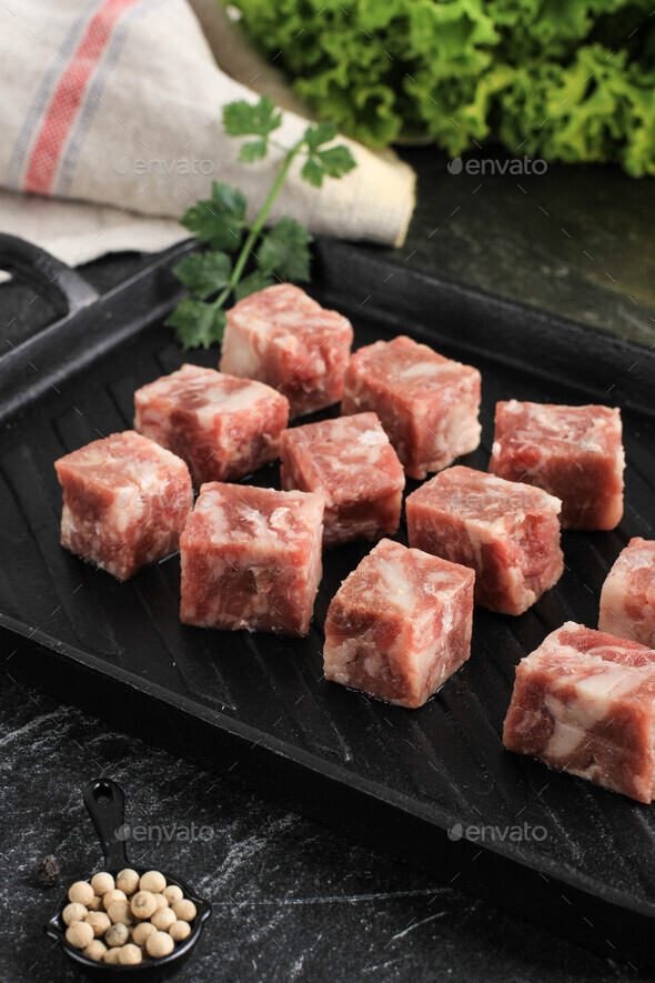 Raw Frozen Saikoro Wagyu Cubes or Dice Beef Steak on Black Steak Plate ...