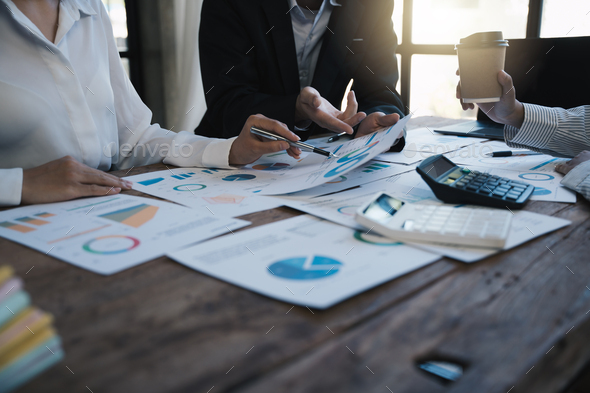 group of employees analyzing financial performance, focus at monthly ...