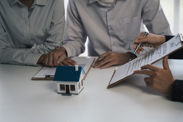 Customer writing signing signature on paper contract with real estate ...