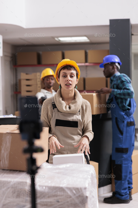 Warehouse operator showing buyer picking and packing at camera Stock ...