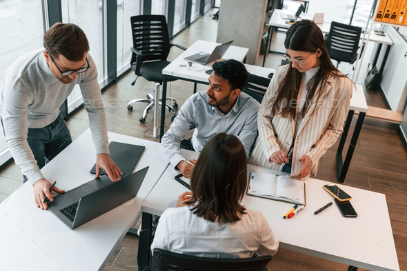 Conception of teamwork. Four people are in the office together Stock ...