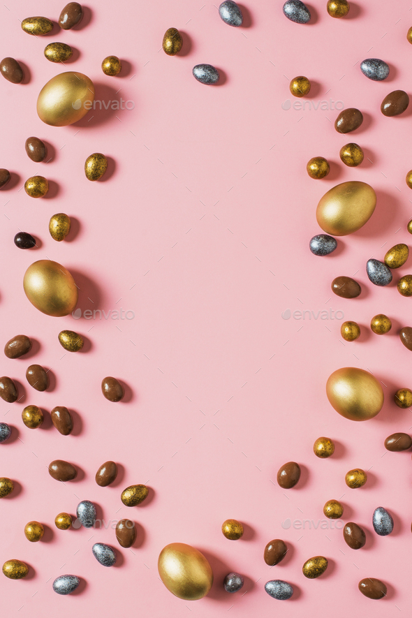 Easter concept card with golden eggs and candy sweet frame falt lay on ...