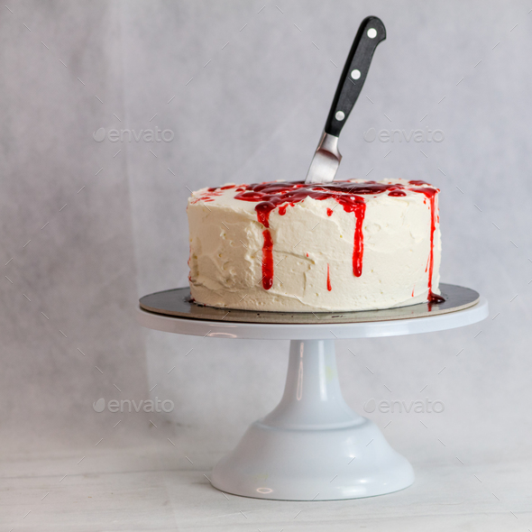designer chef decorating white red bloody horror crime cake for ...