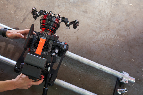 close-up male hands of a videographer roll and set up a professional ...