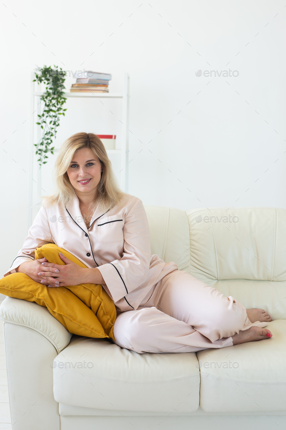 Cute female model in pajama enjoying morning. Pleasant woman sitting on ...