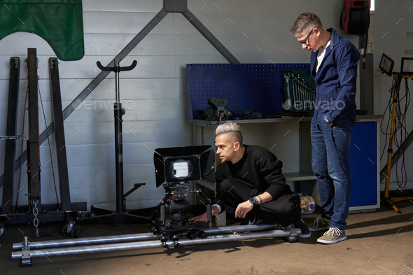 cameraman and director set up a professional video camera before ...