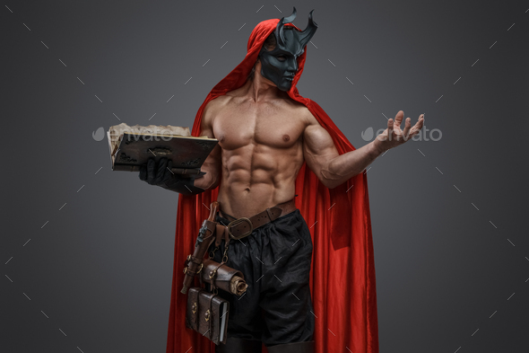 Dark cultist with muscular body and horned mask holding book Stock ...